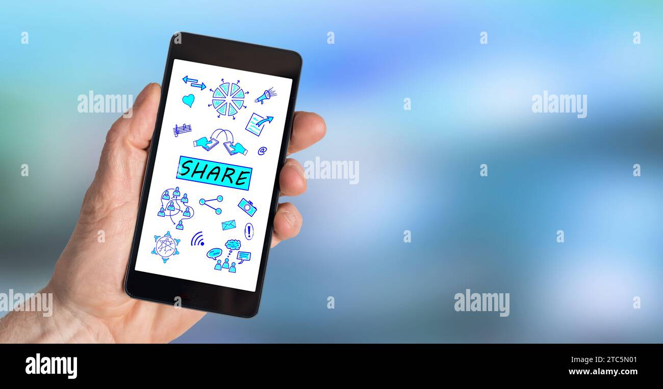Hand holding a smartphone with share concept Stock Photo - Alamy