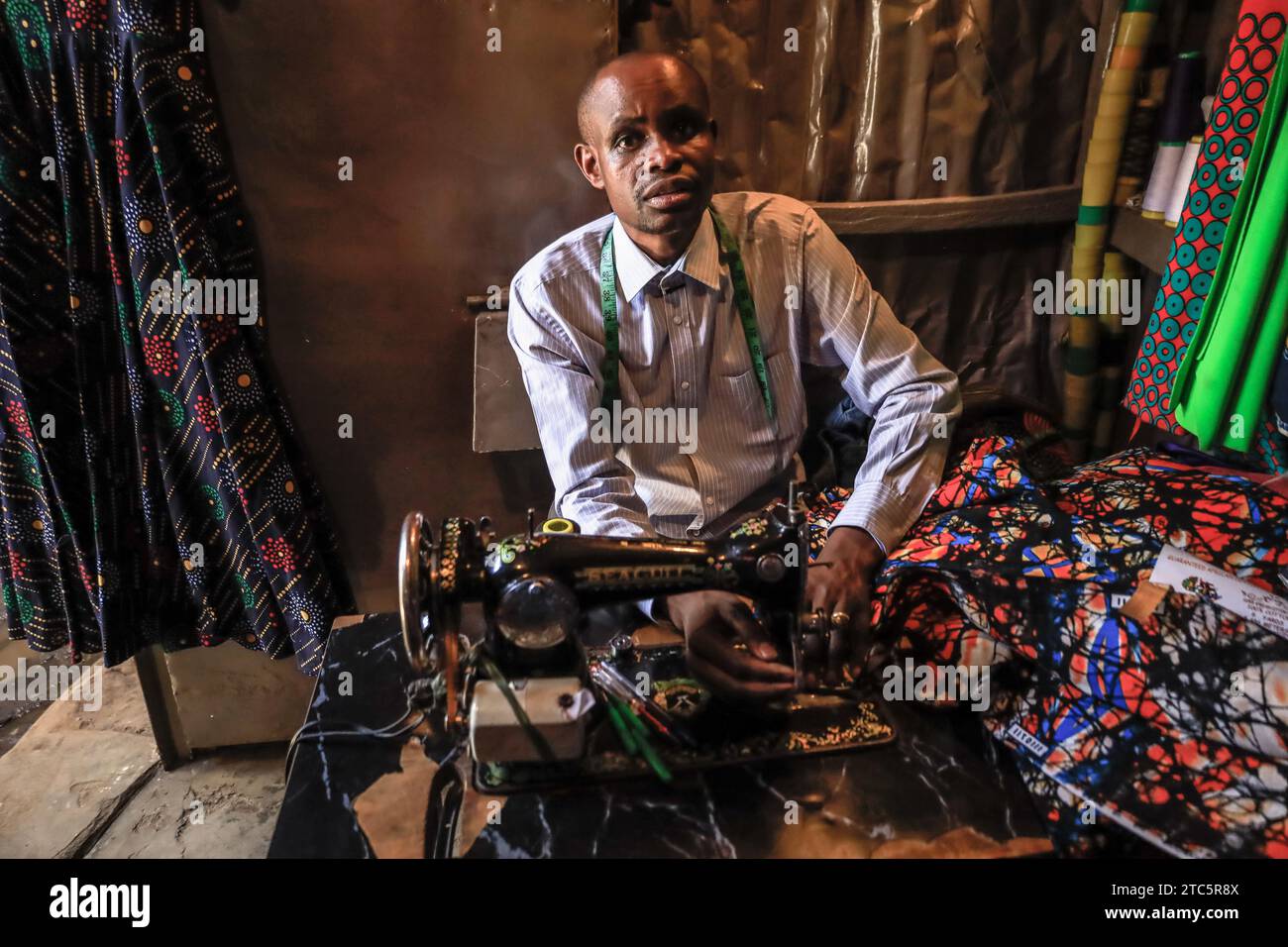 Richard Onyango a tailor at Afrowema thrifts fabric clothes at his ...