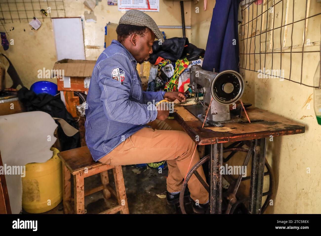 George Otieno a shoe maker from Kibera makes shoes using fabrics from ...