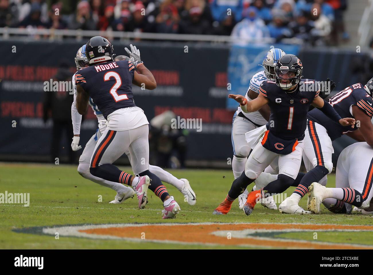 Chicago Bears quarterback Justin Fields (1) flips the football to Chicago Bears wide receiver DJ ...