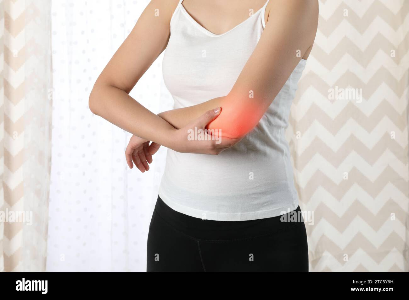 Woman suffering from elbow arthritis is touching her elbow Stock Photo ...