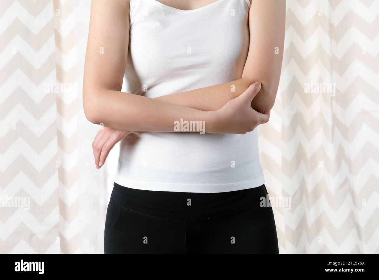 Woman suffering from elbow arthritis is touching her elbow Stock Photo ...