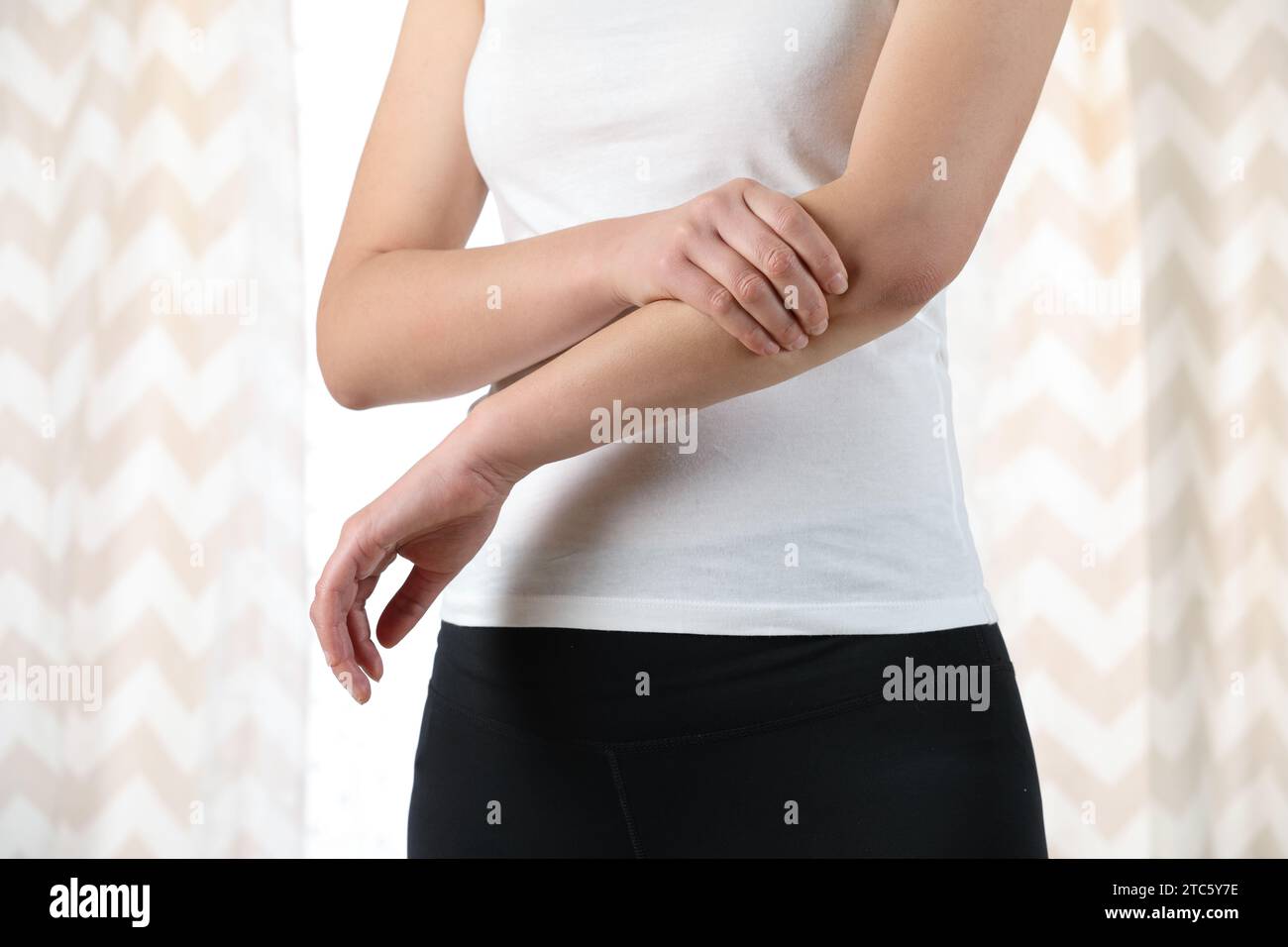 Woman suffering from elbow arthritis is touching her elbow Stock Photo ...