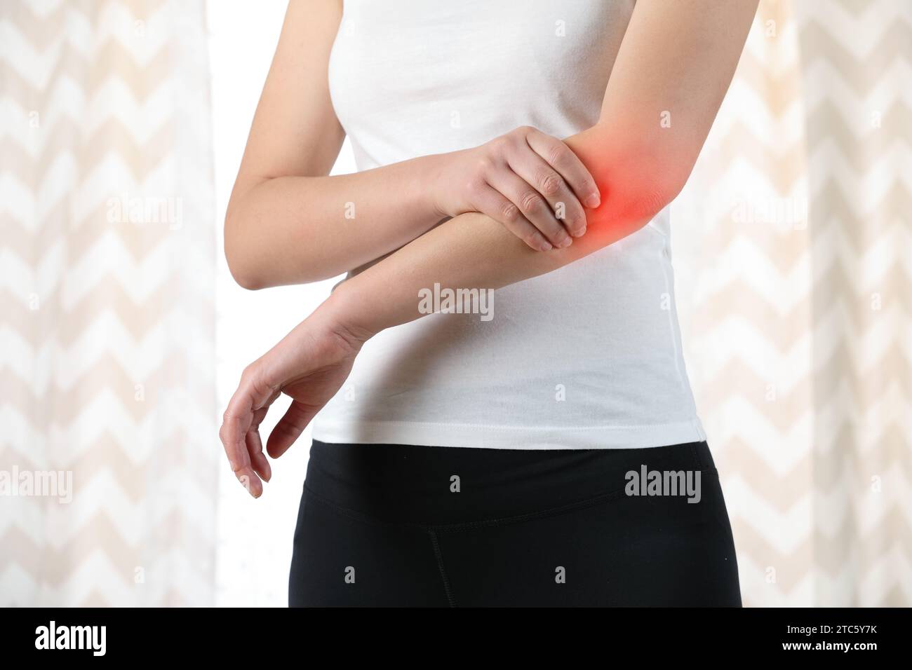 Woman suffering from elbow arthritis is touching her elbow Stock Photo ...