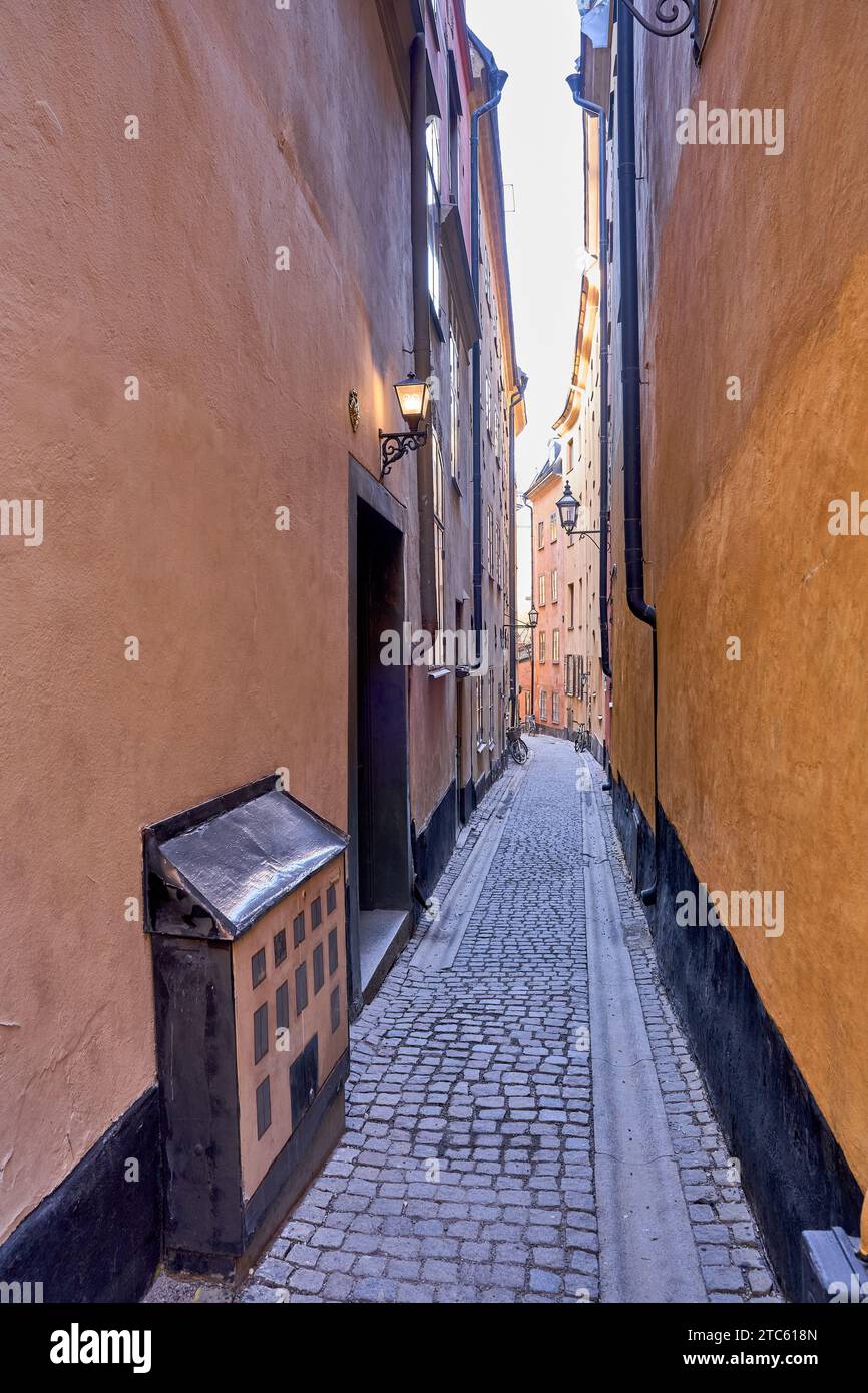 A scenic alleyway between two traditional European buildings ...