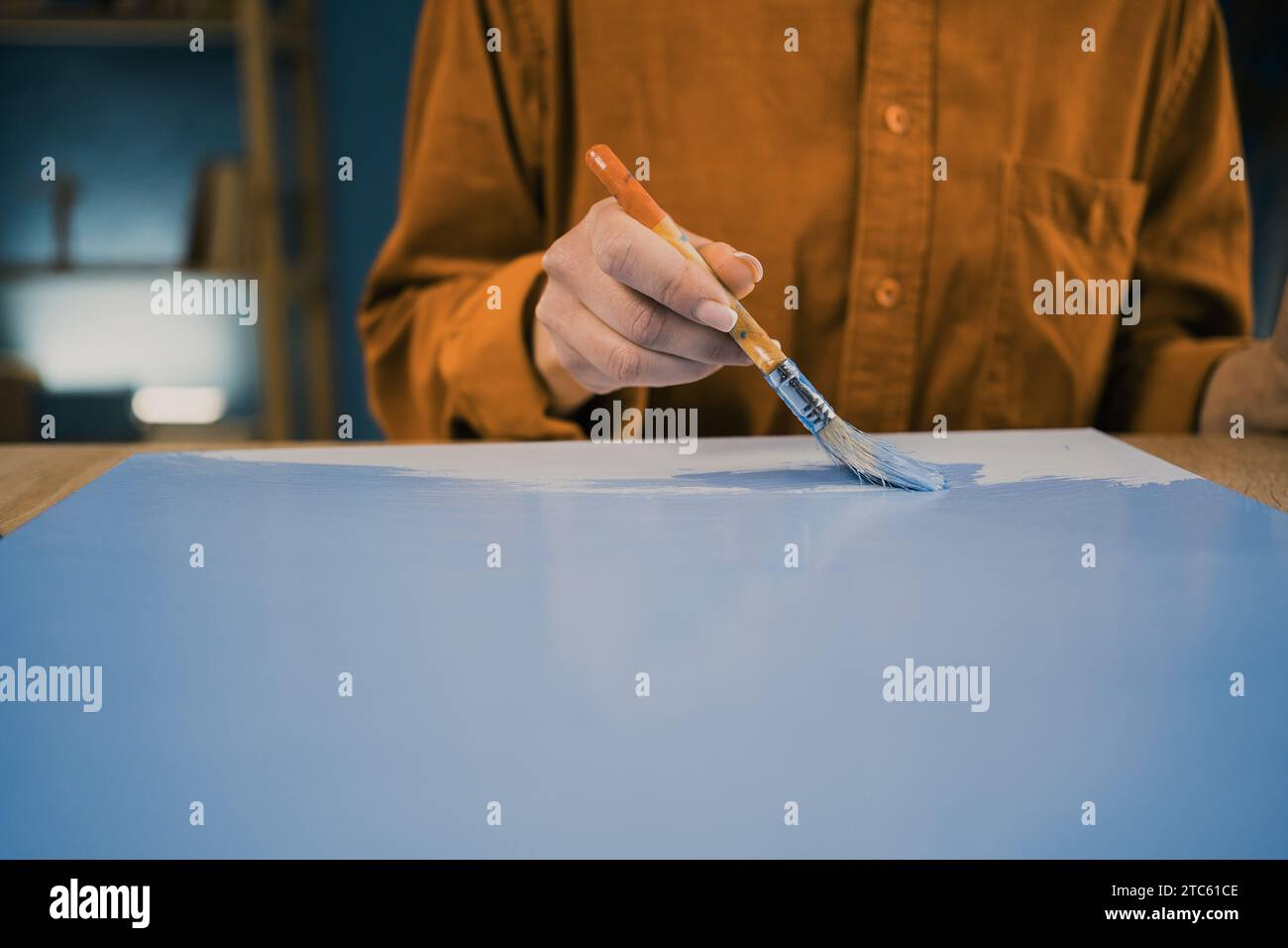 Close-up of female artist works on abstract painting, moving paint ...