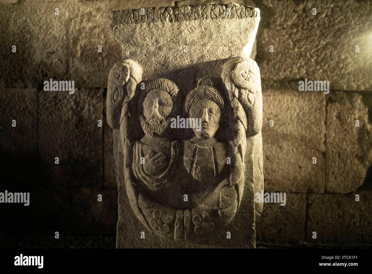 There are some grave headings and artifacts exhibited on the lower ...