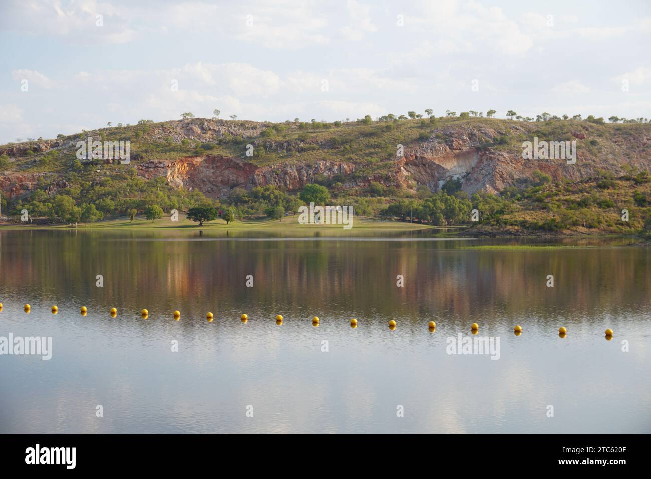 Scenic mirror reflection view over Lake Moondarra with string of buoys ...