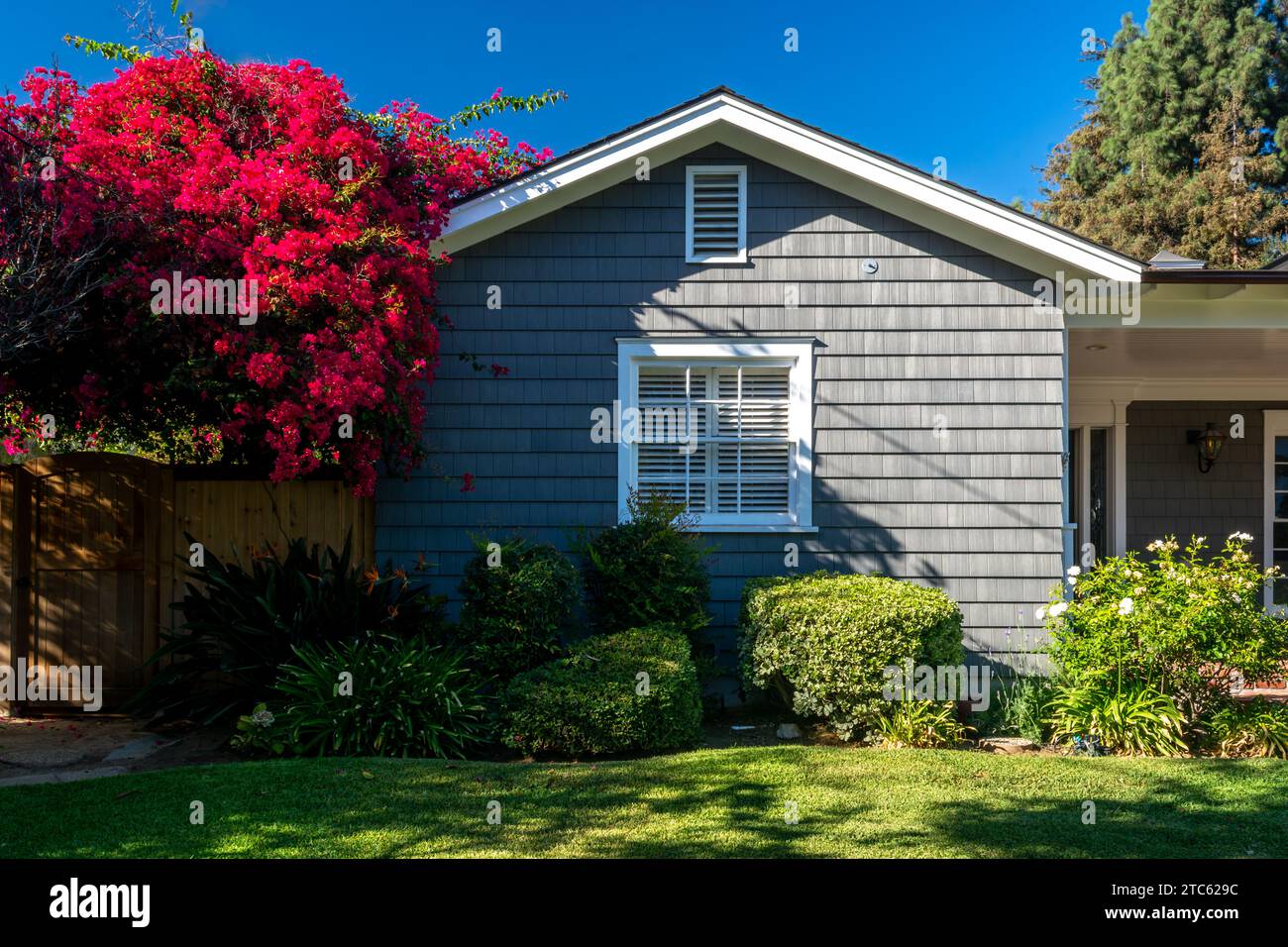 A classic American suburban house with a bright and vibrant flower ...