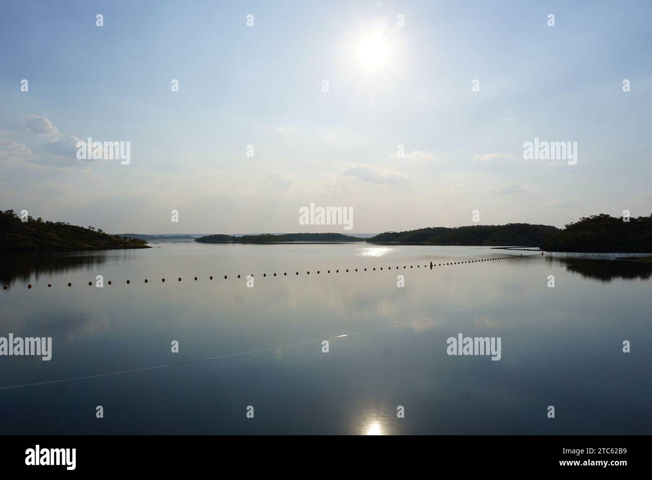 Scenic mirror reflection view over Lake Moondarra with string of buoys ...