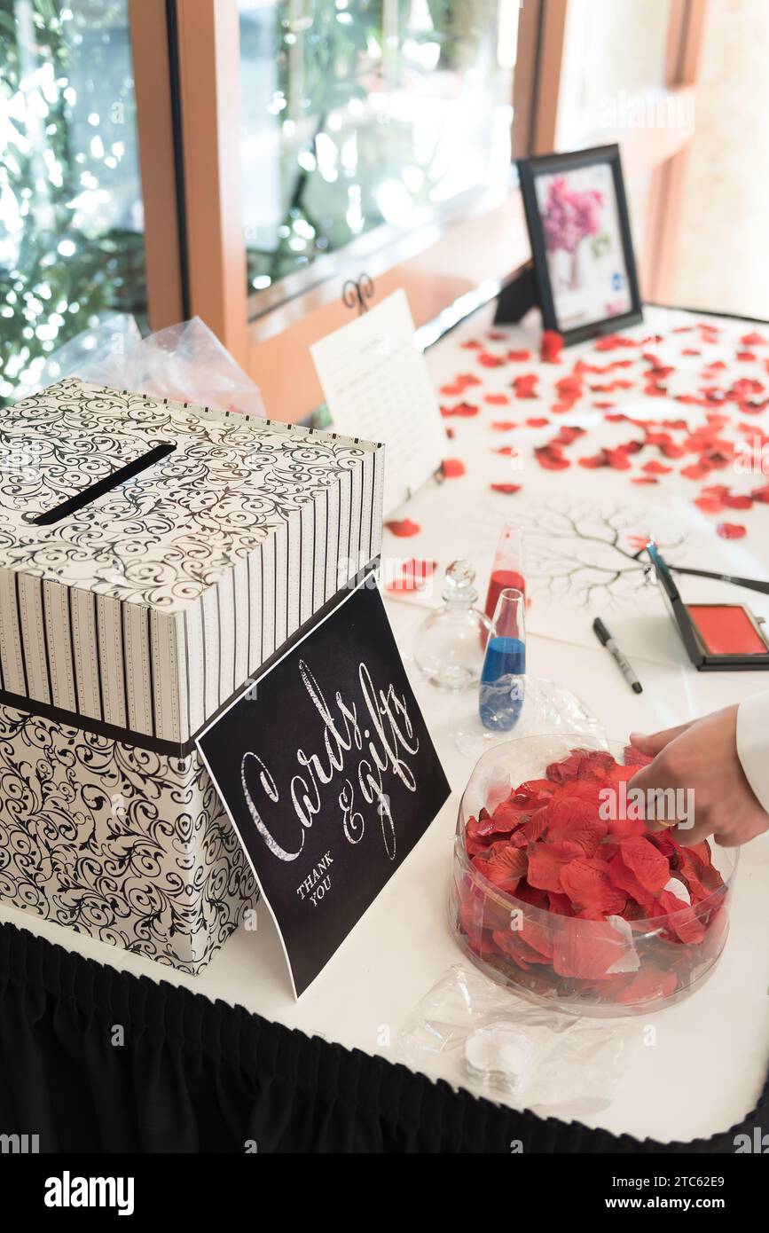 A white artboard on a table, serving as a guest register for a wedding ...