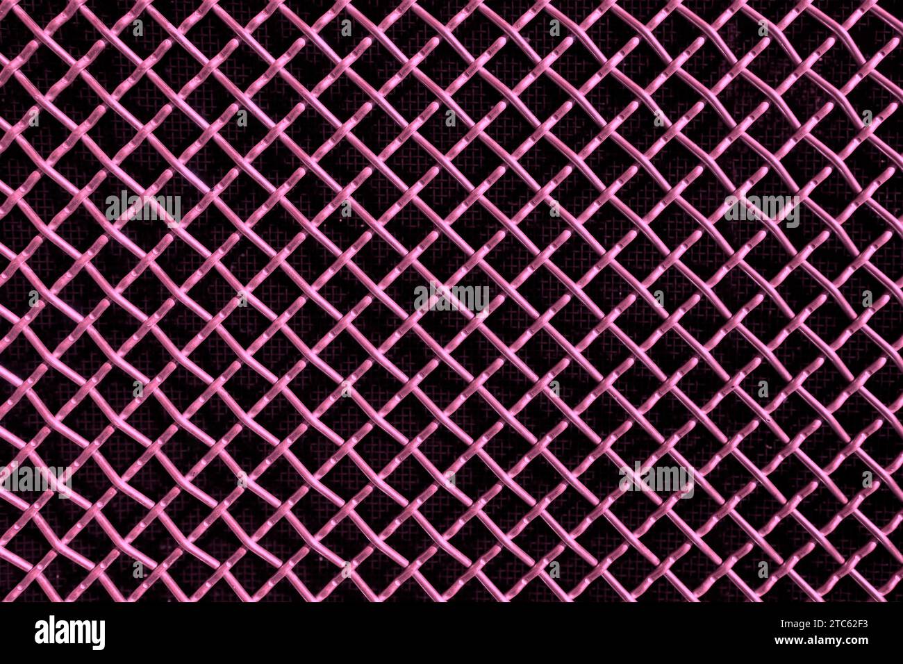 pink metal mesh or aluminum grid with regular pattern on black ...