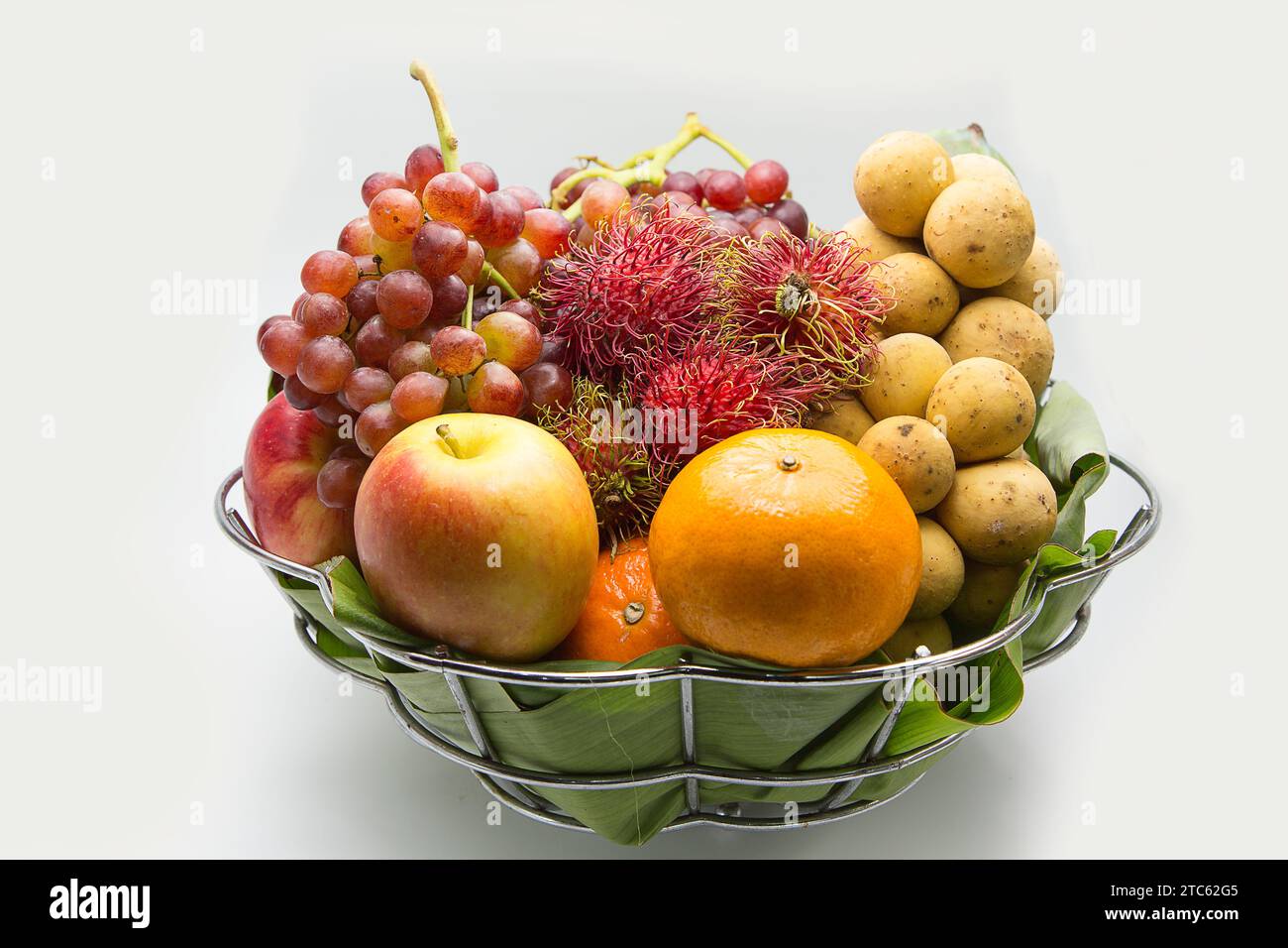 Assortment of exotic fruits in aluminum basket Stock Photo - Alamy
