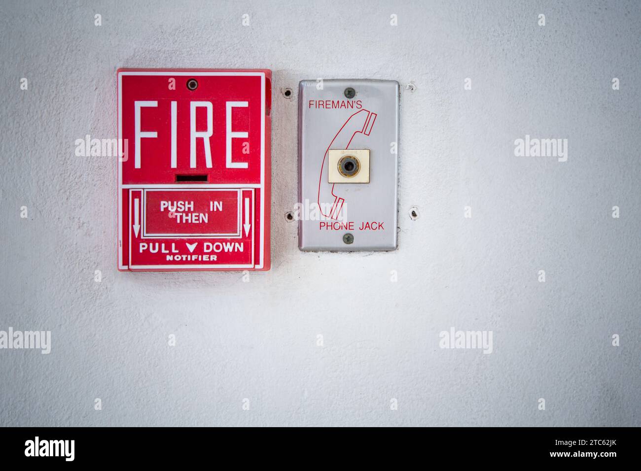 Red fire alarm switch at cement wall Stock Photo - Alamy