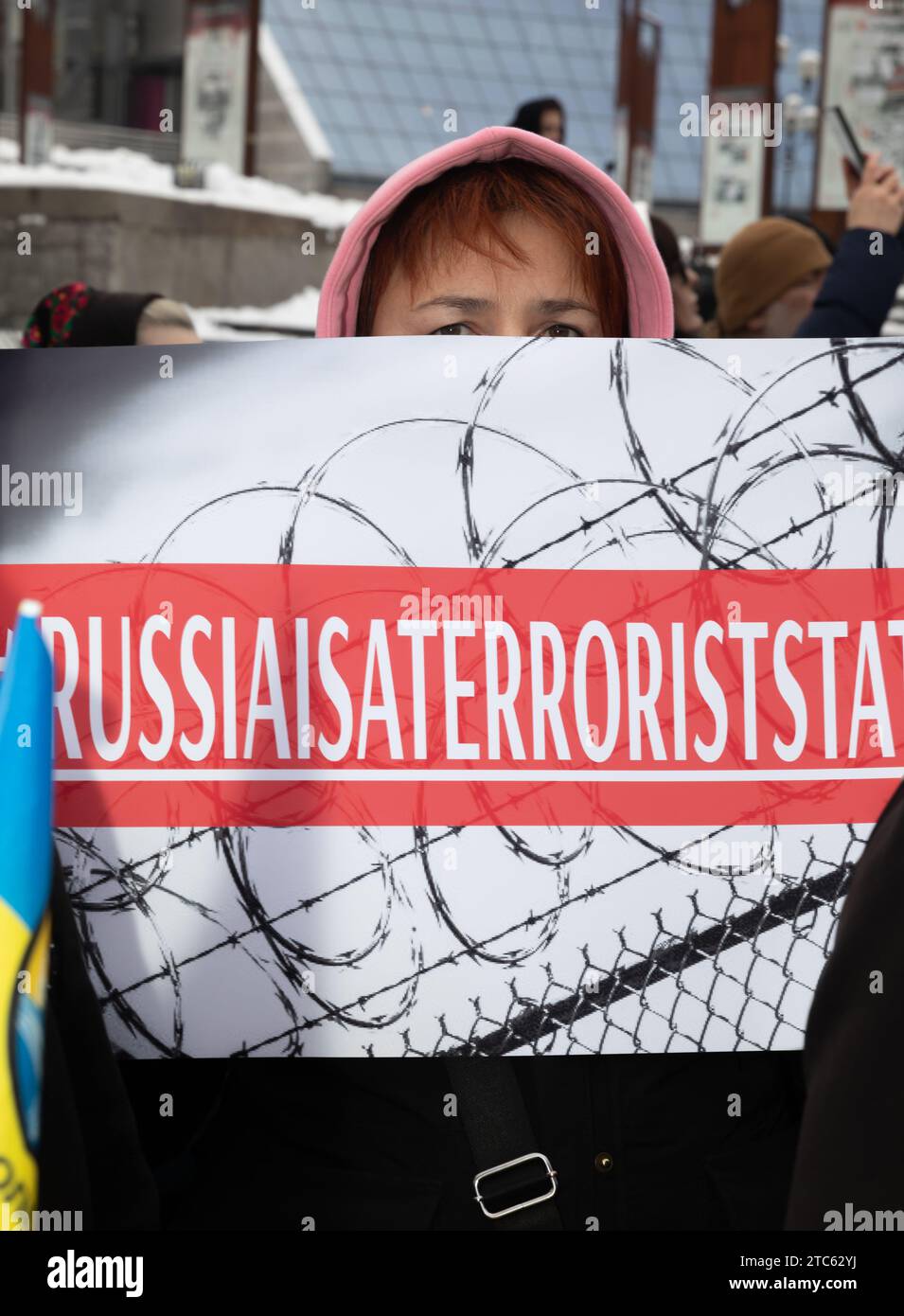 A woman is seen holding a placard saying Russia is a terrorist state ...