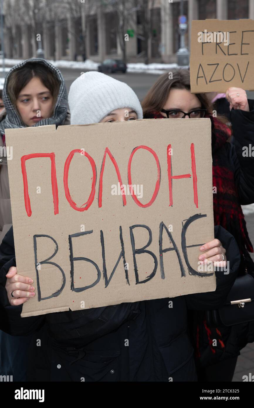 A POW's wife is seen in tears holding a placard with the words ...
