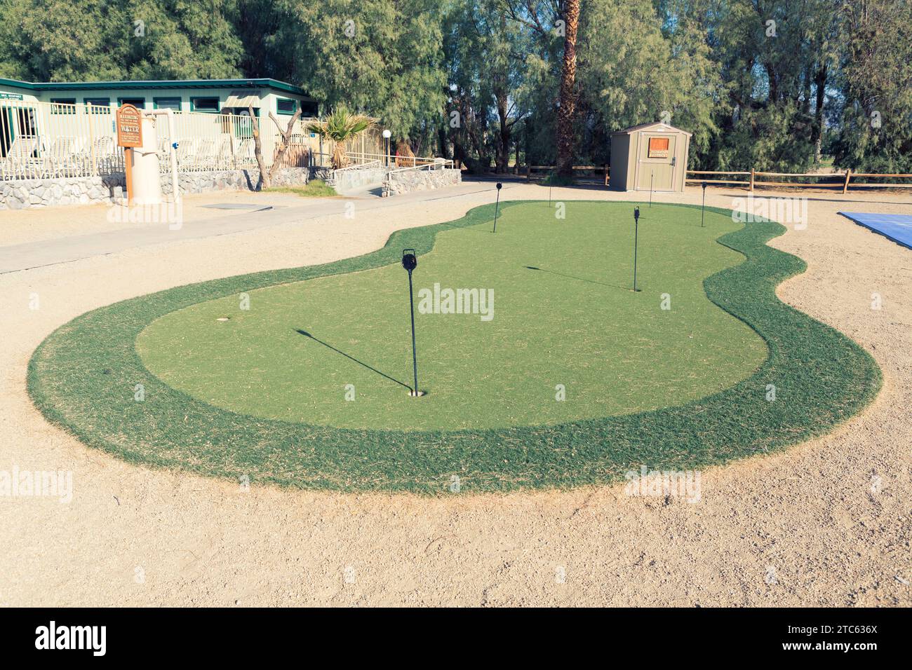 Golf hole in putting green. The putting green is a mini golf course to ...