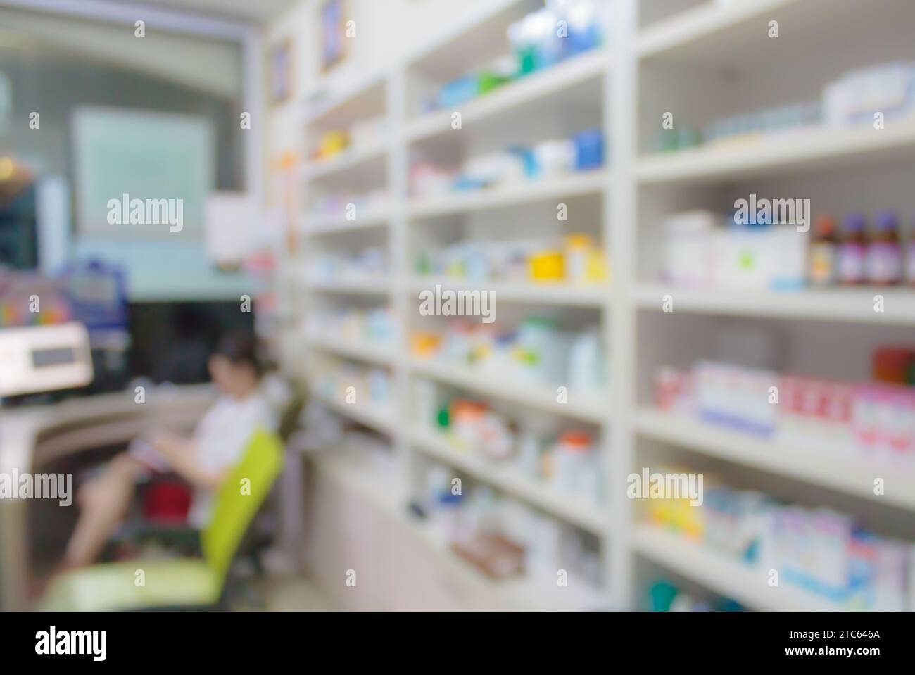 pharmacist in the pharmacy store drugs shelves interior blurred ...