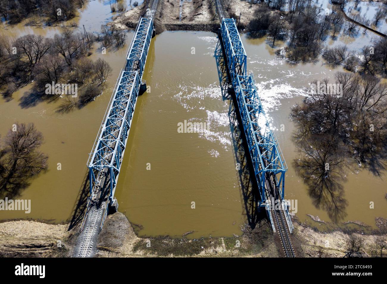 View from above of railway bridges across the river during spring flood ...
