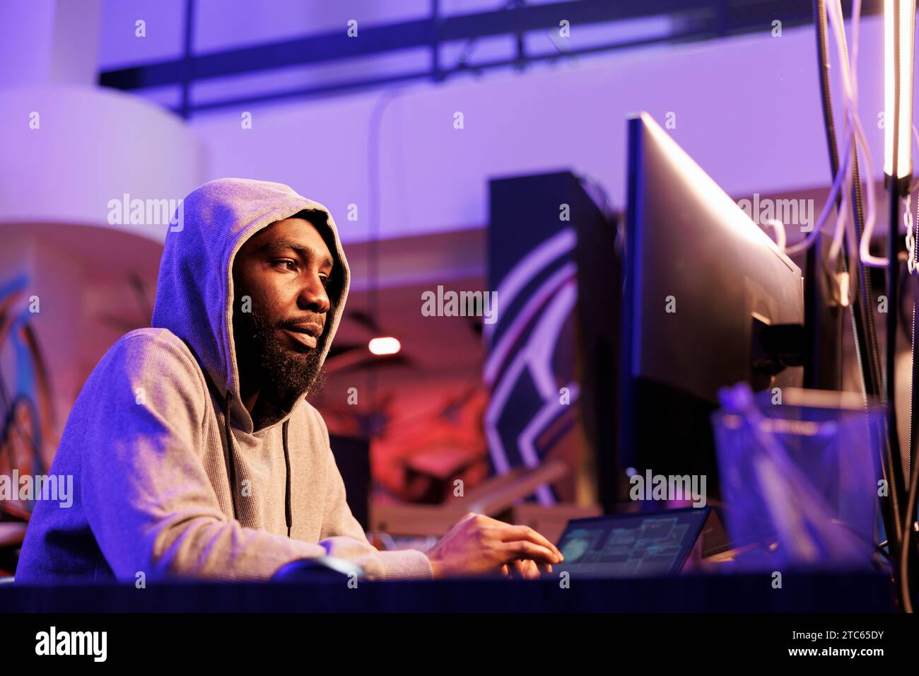 African american criminal hacking online server and stealing information. Hacker in hood ...