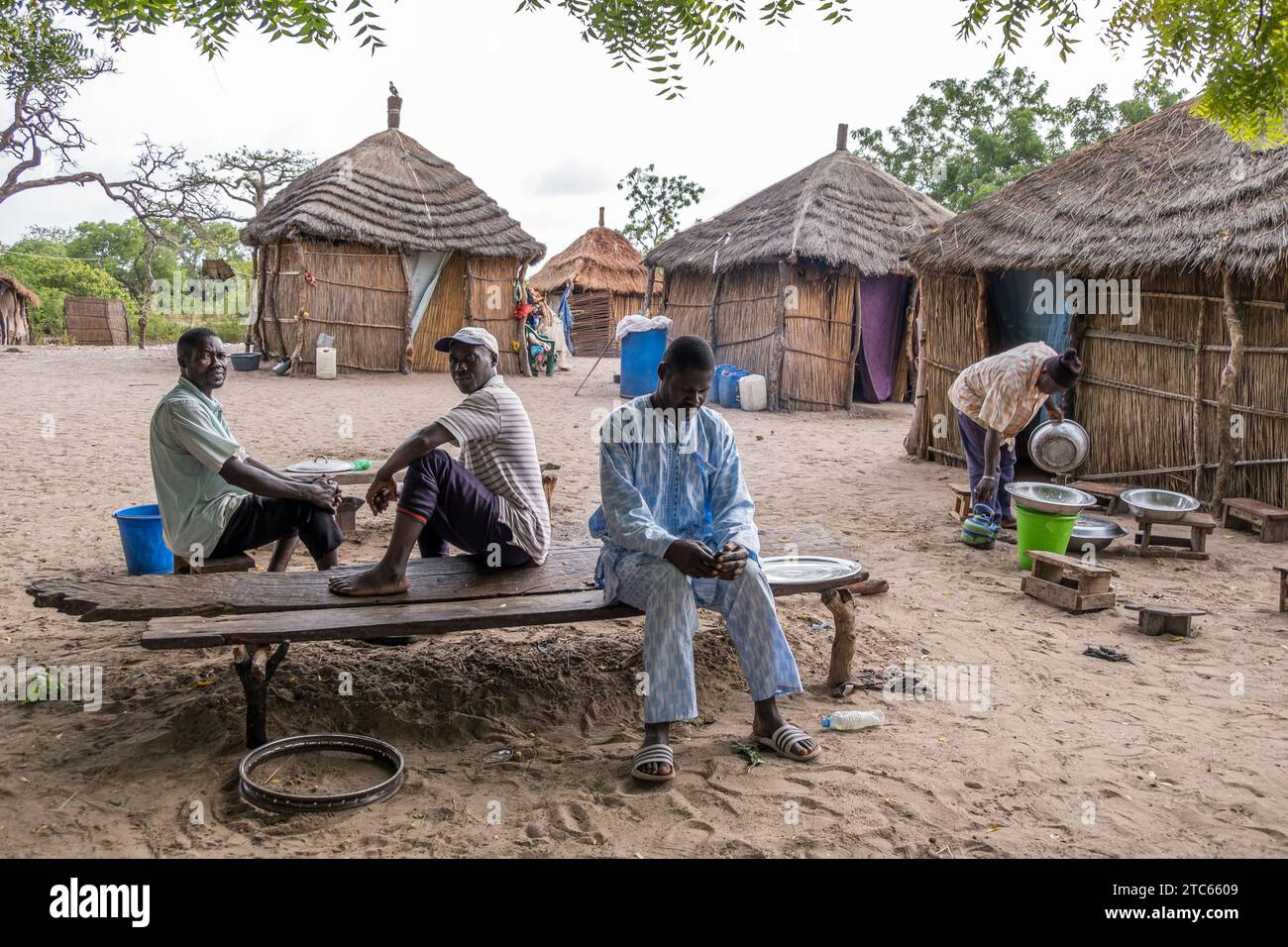 Group of men sitting inside the village of Sipo in the Sine and Saloum ...
