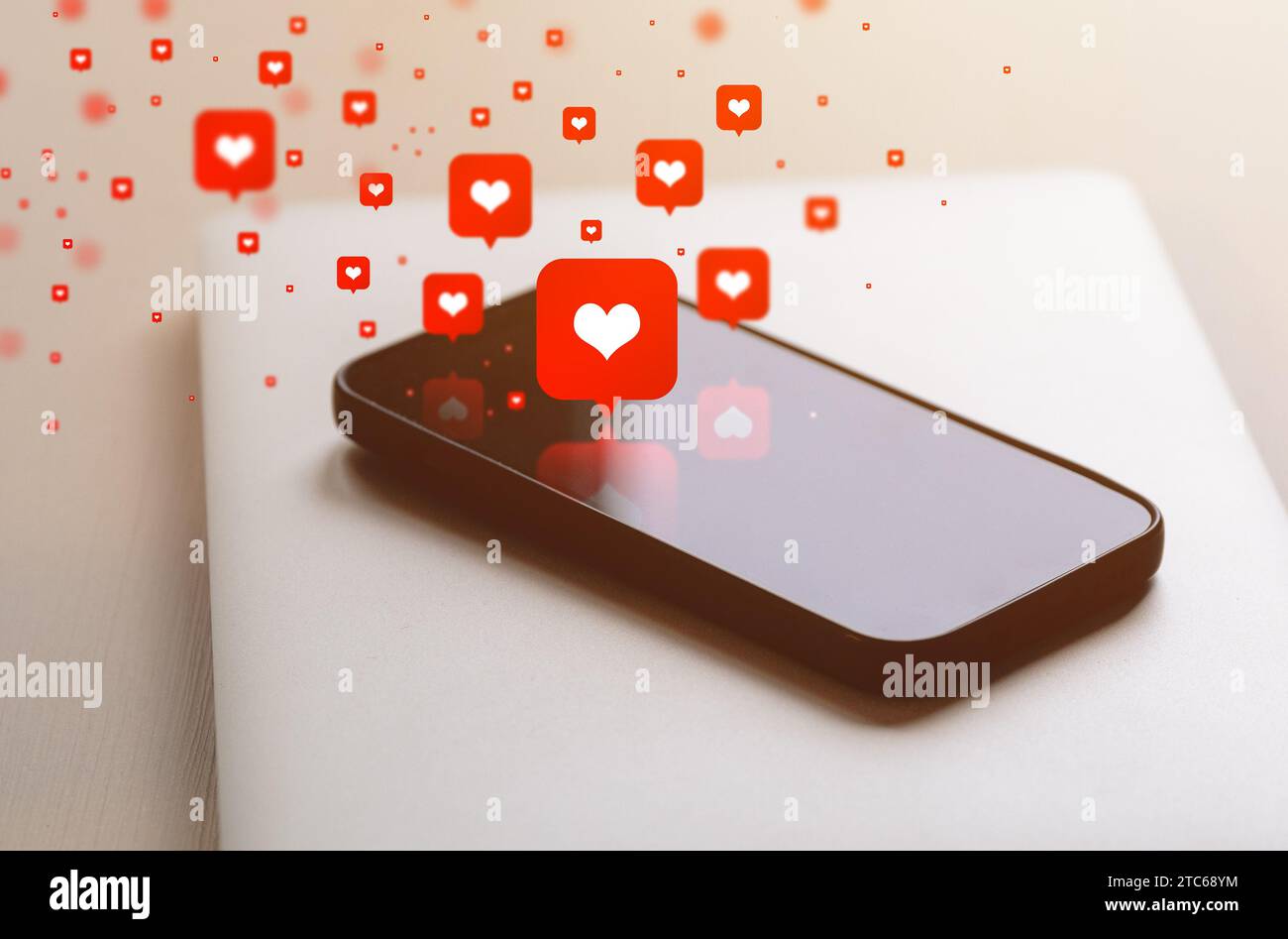 Smartphone with many heart-shaped Like notification buttons for social ...