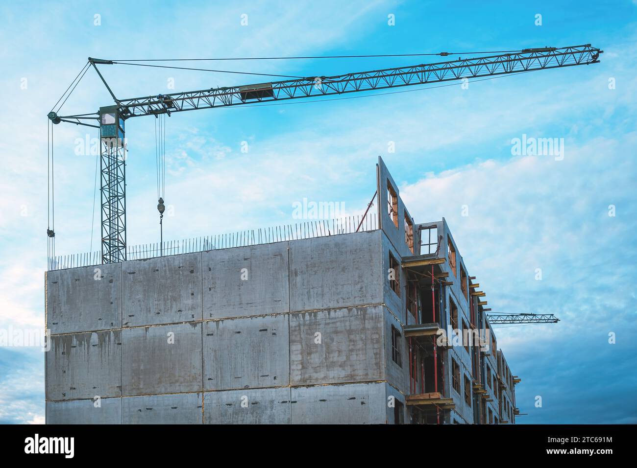 Tall prefabricated residential building construction site with old ...