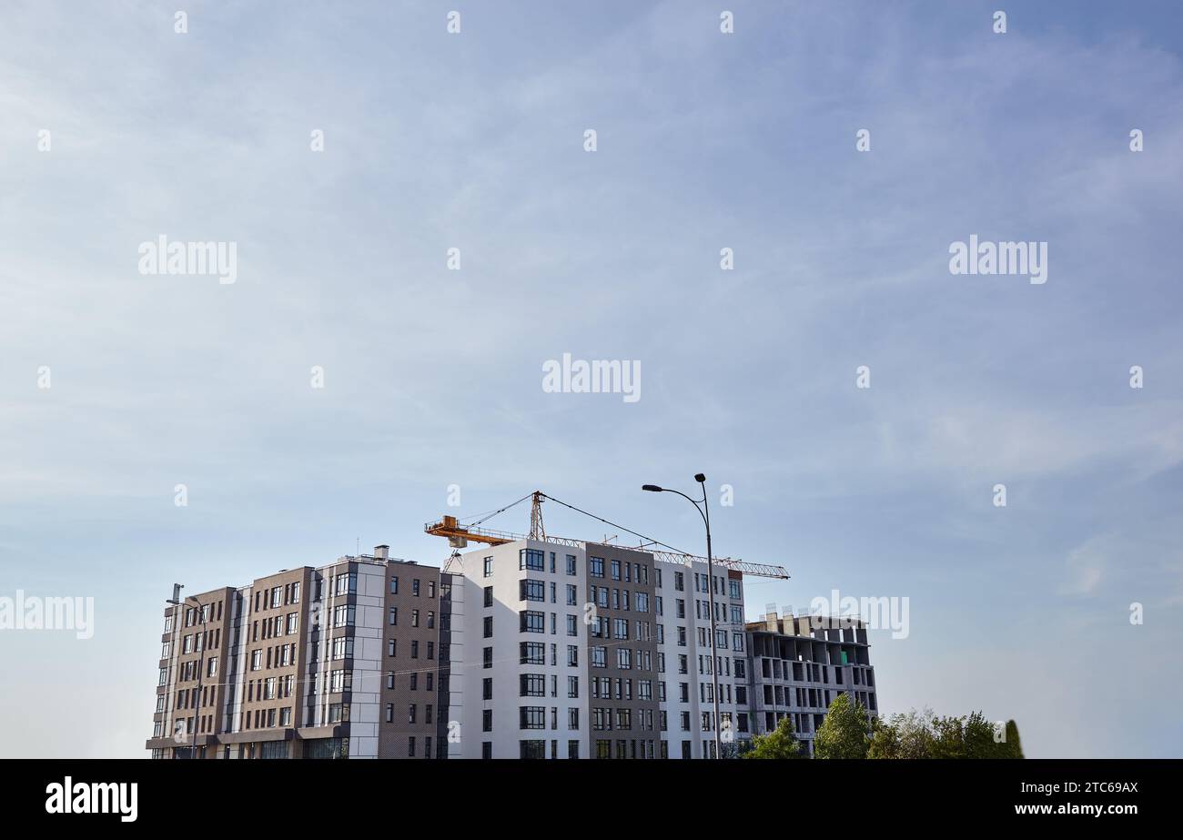 Fragment of tower crane, building a house. Concrete building under ...