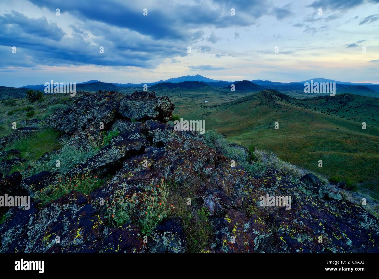A scenic landscape featuring green hills and a cloudy sky. Colton ...