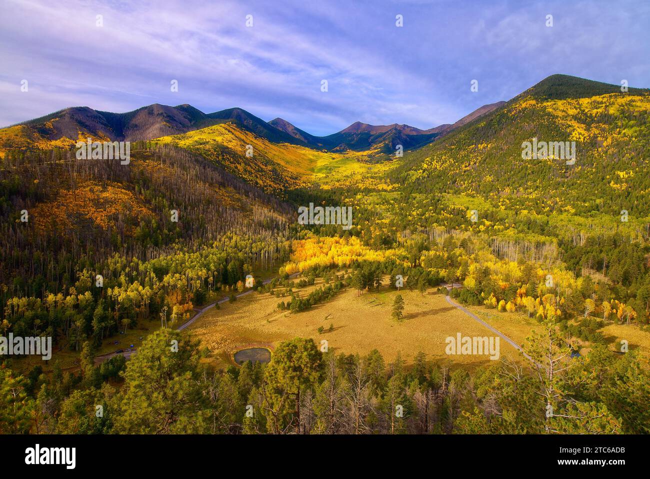 A scenic view of a mountain range covered with vibrant autumn woods ...
