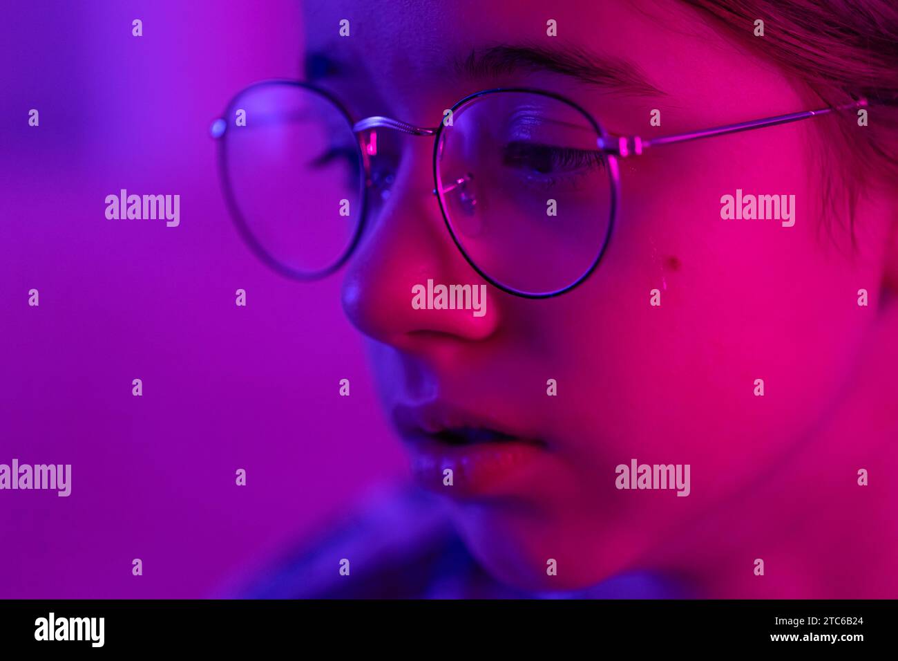 Cute girl with glasses crying in neon light, face close-up Stock Photo ...