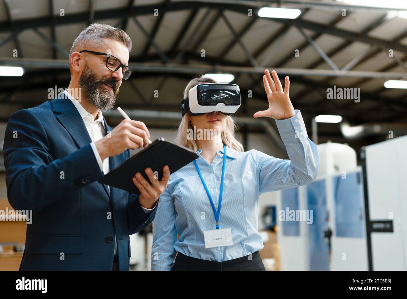 Engineers talking project using VR, in modern industrial factory ...