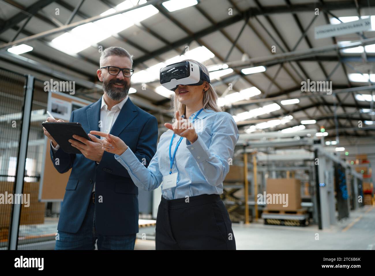 Engineers talking project using VR, in modern industrial factory. Virtual reality in ...