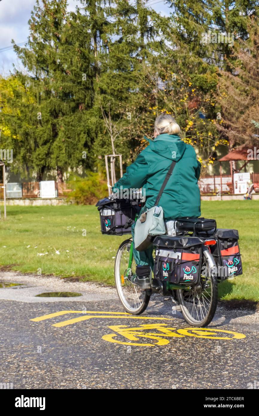 Woman, postman of the Hungarian Post (Magyar Posta) on an electric ...