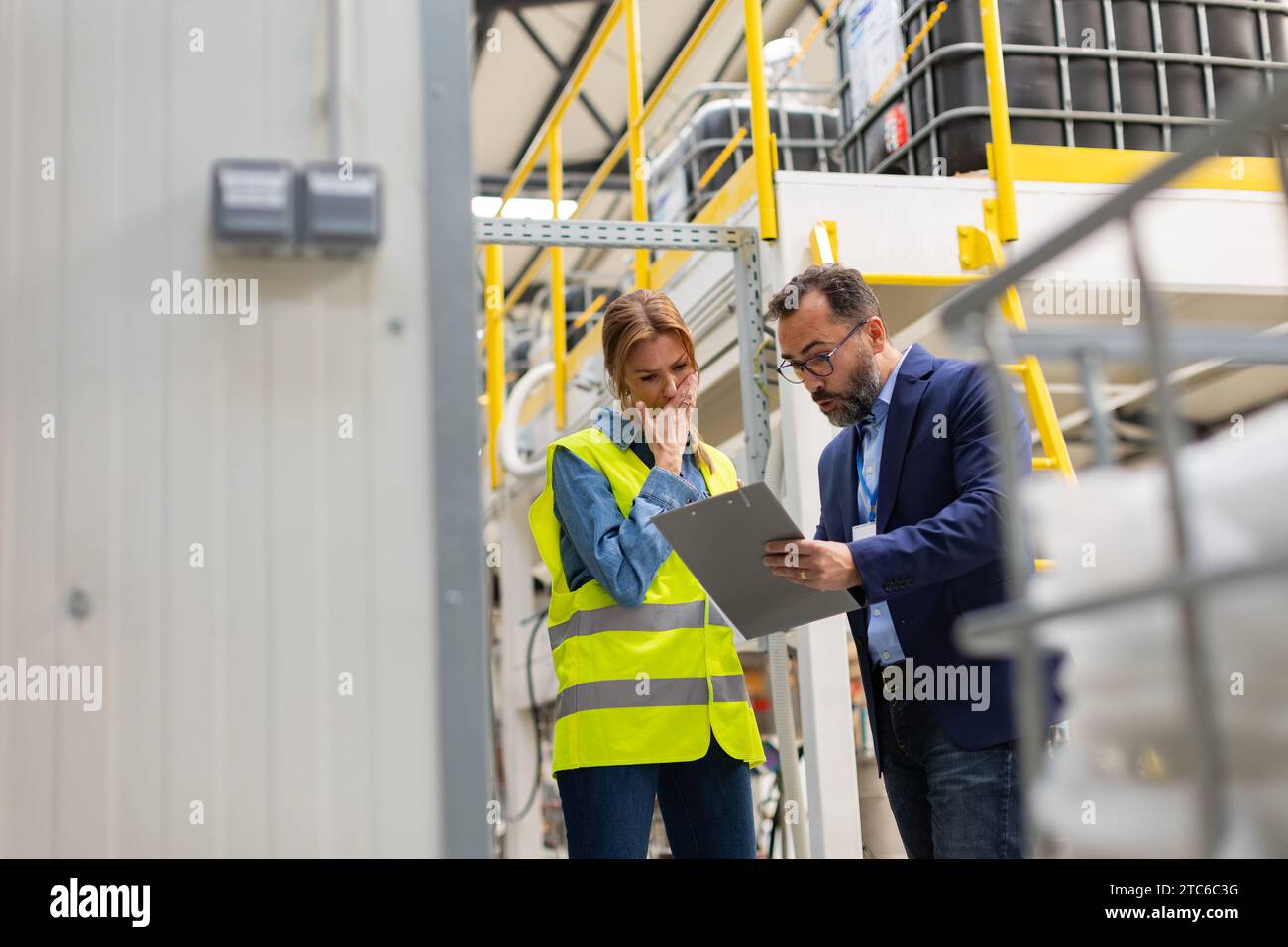 Supervisor, manager scolding employee in modern industry factory ...