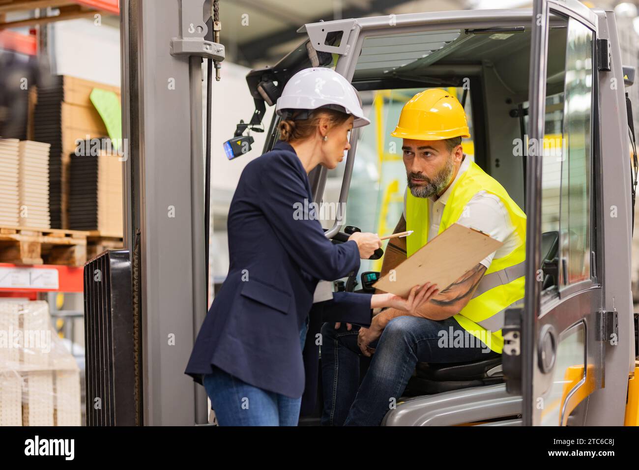 Warehouse management talking forklift driver hi-res stock photography ...