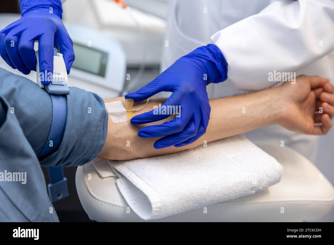 Inserting catheter into vein in patient's arm in hospital medicinal ...