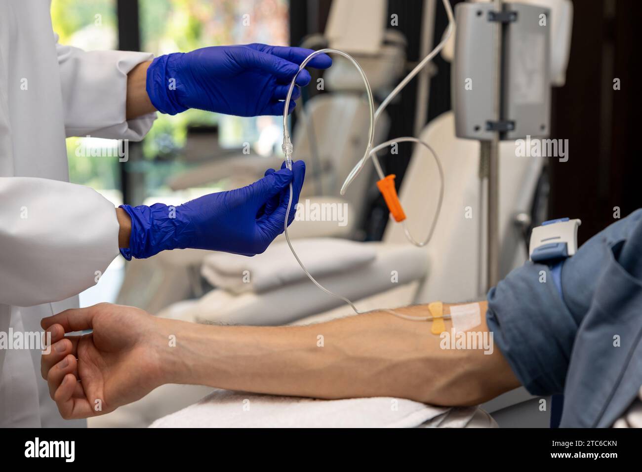 Patient man receiving infusion drip in hospital or beauty salon Stock ...
