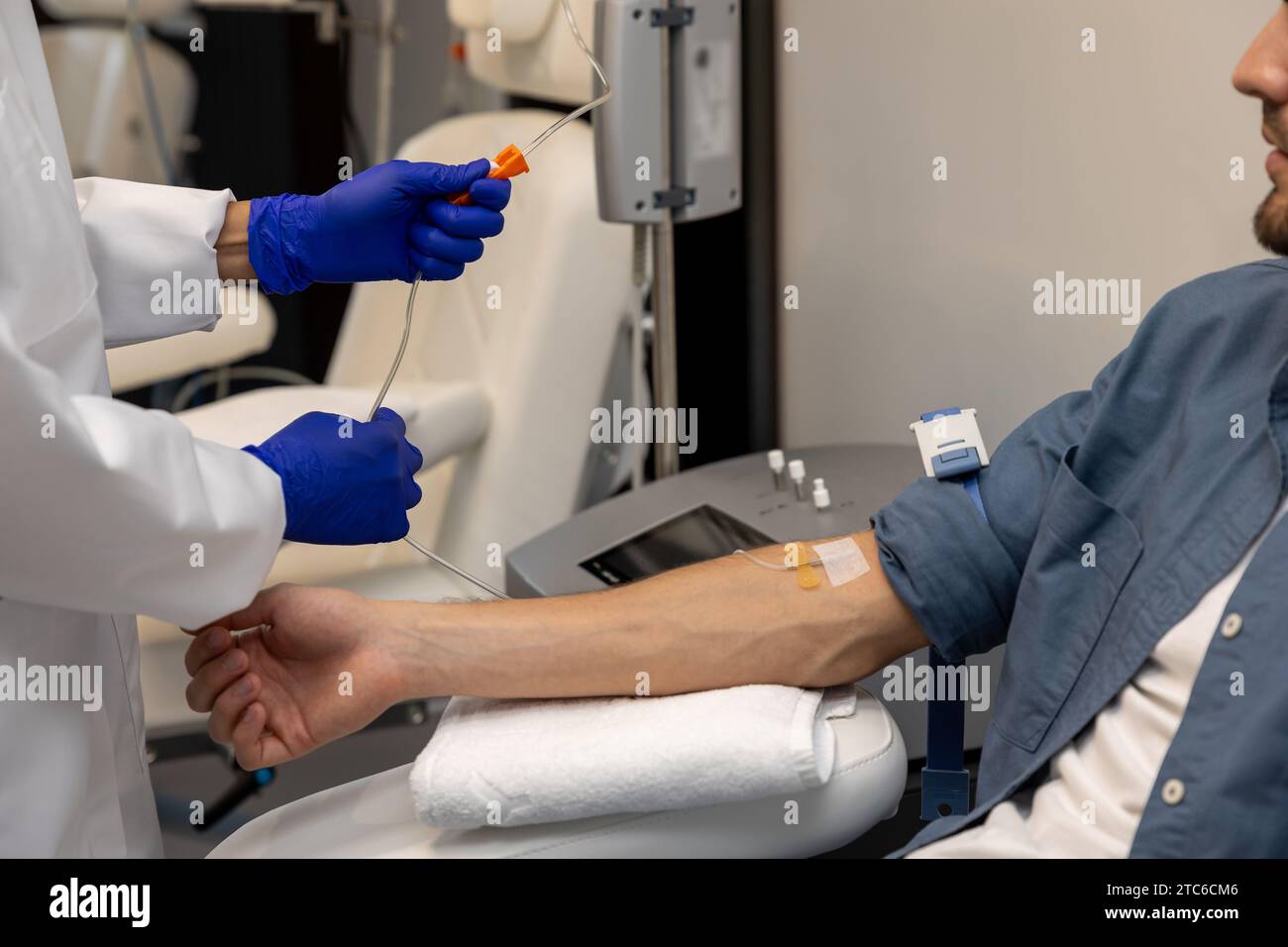 Inserting catheter into vein in patient's arm in hospital medicinal ...