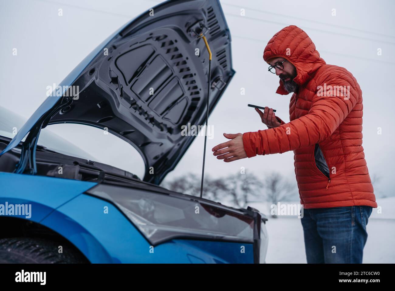 Angry man standing by electric car, battery run out of power before ...