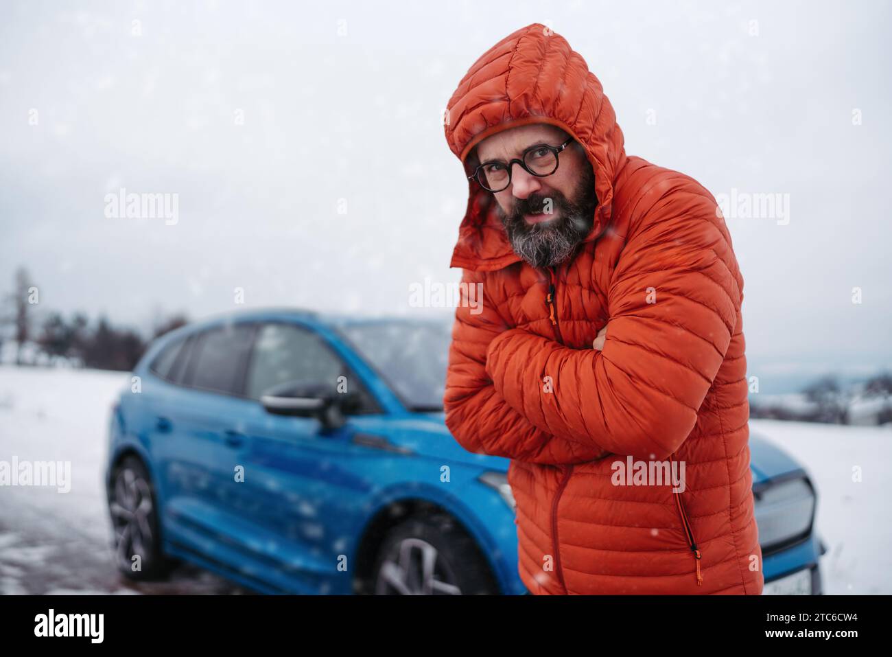 Angry man standing by electric car, battery run out of power before ...