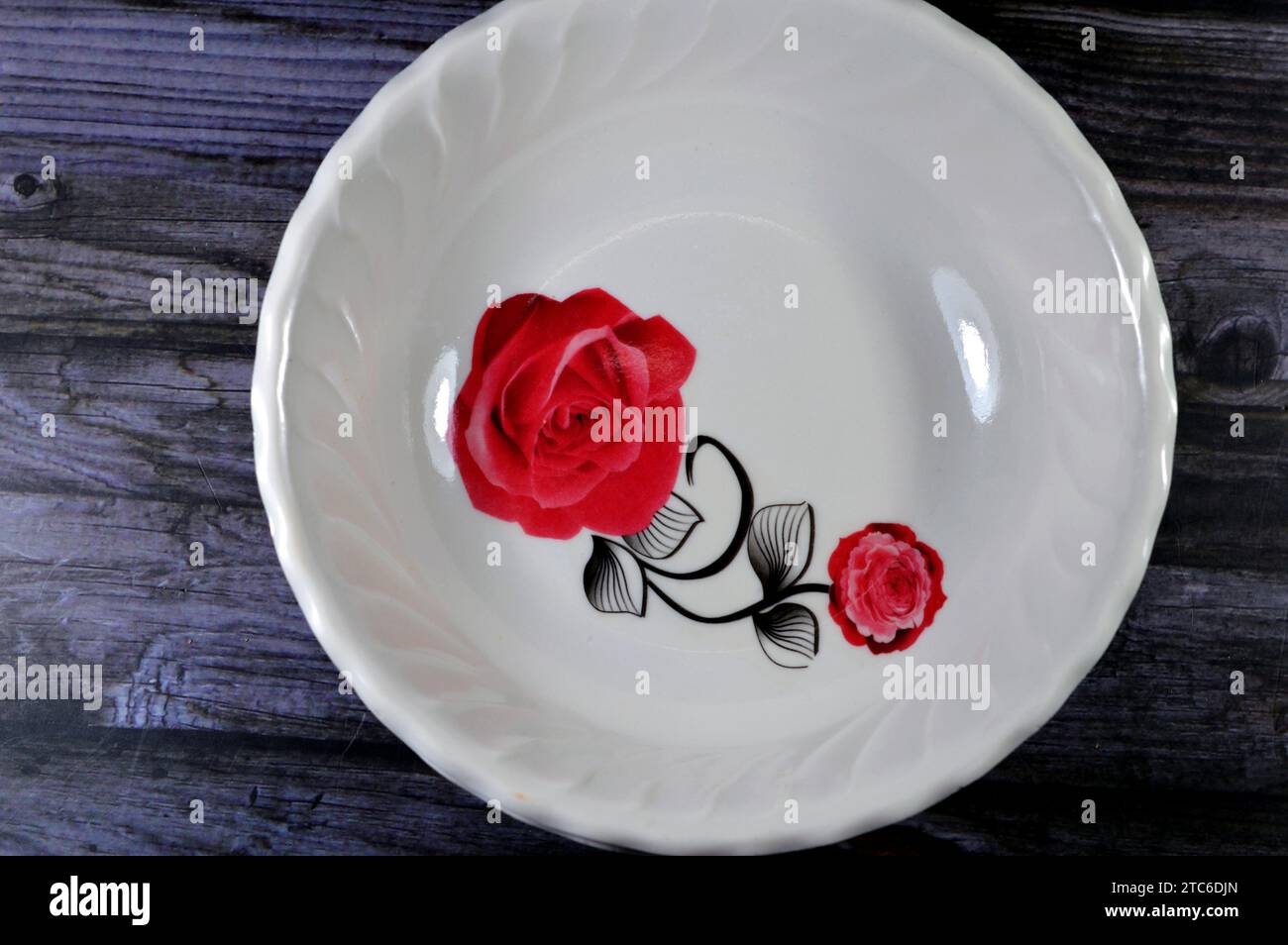 empty food plate used for serving food, with a picture of a red rose ...