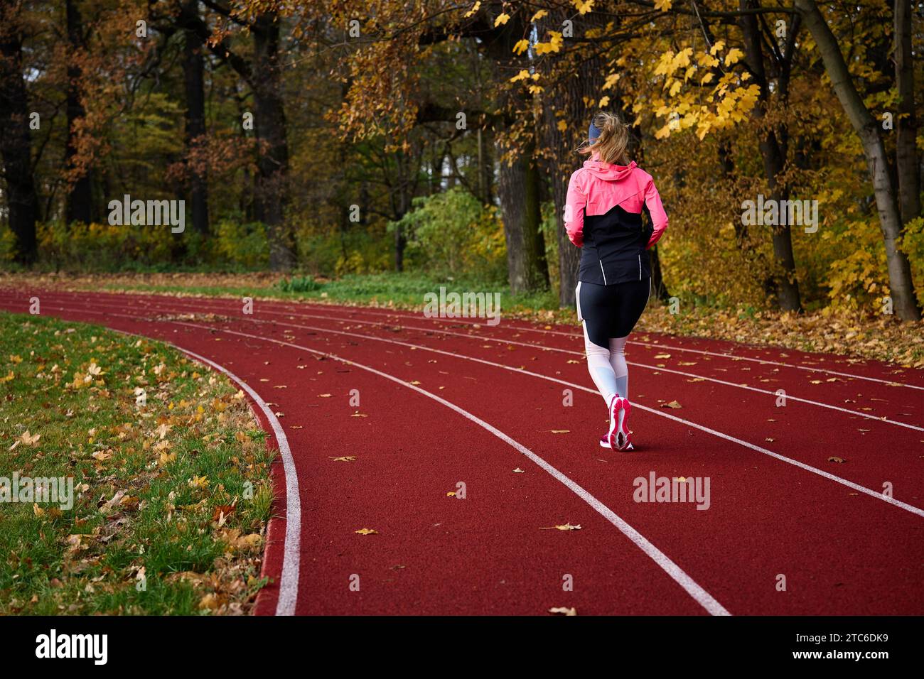 Woman running at track. Female runner jogging at stadium. Active sport ...