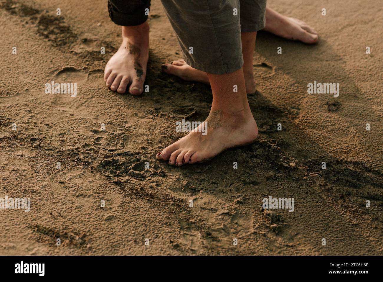 Couples toes in the sand at sunset at the beach Stock Photo - Alamy