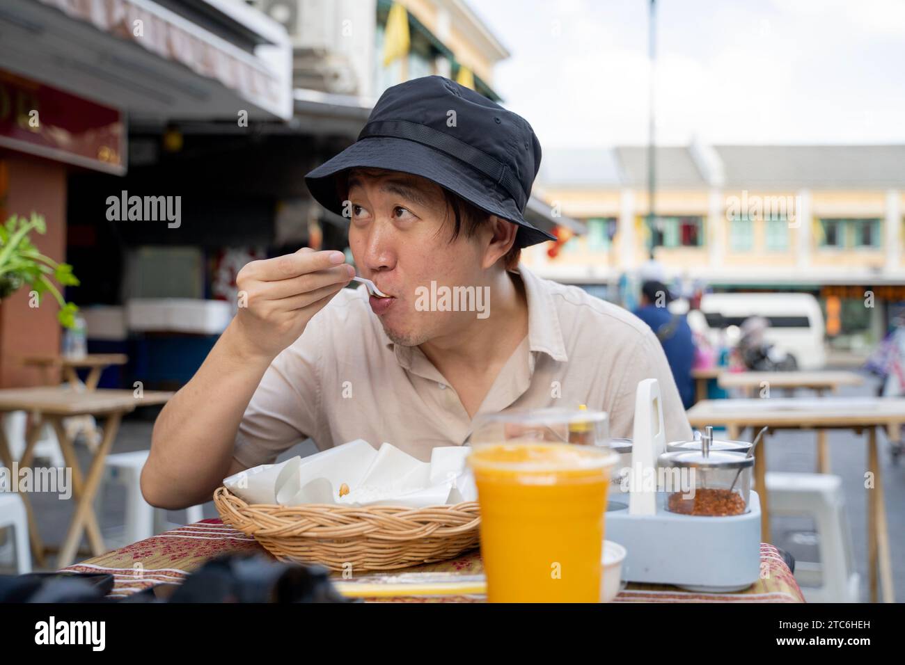 Solo travel food experience: Asian male tourist backpacker eating ...