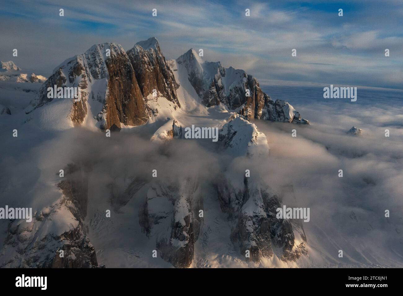 Mountain Moose's Tooth peek above the clouds in Alaska Stock Photo - Alamy