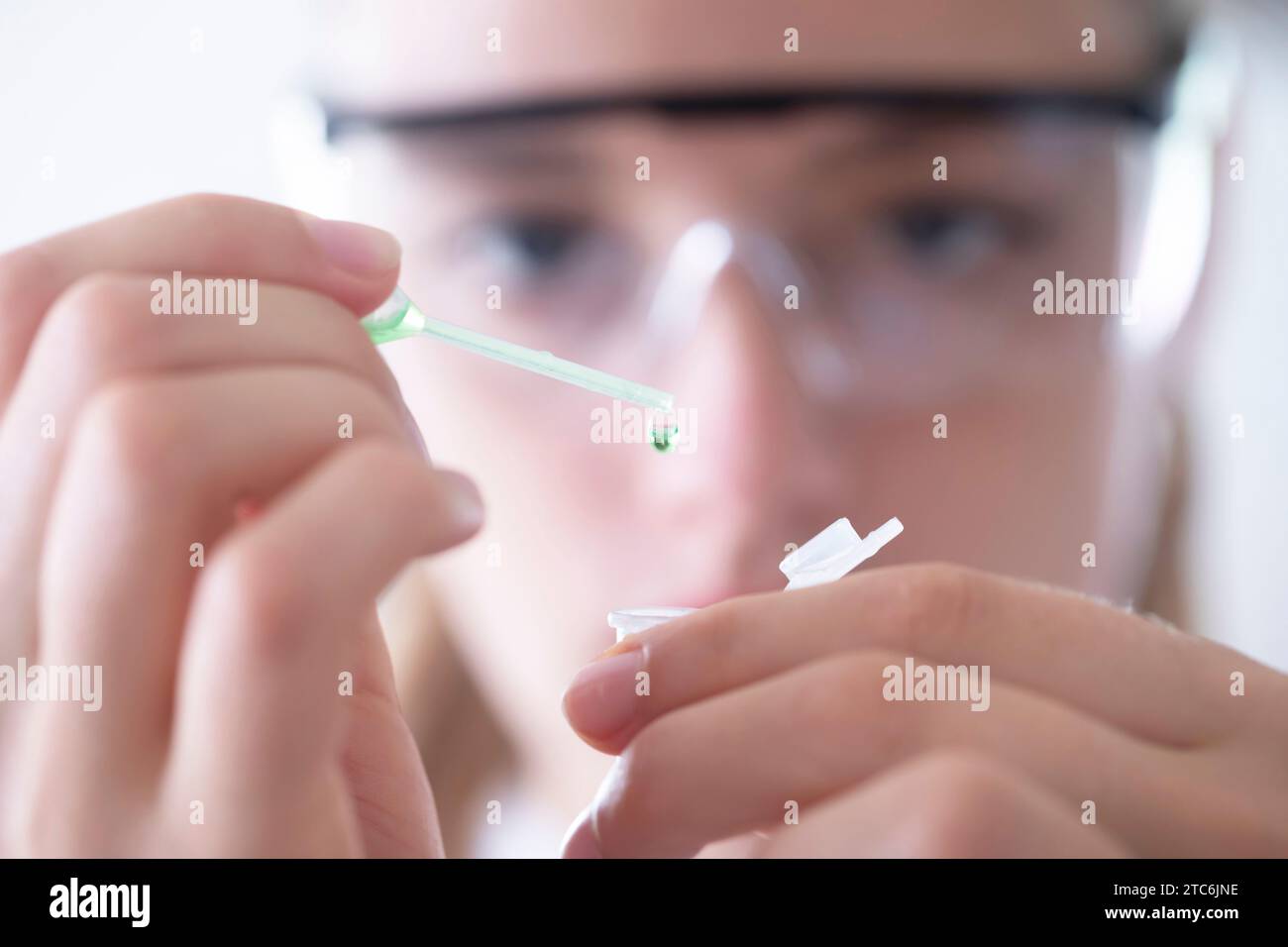 young scientist female with lab glasses dropping with pipette Stock ...