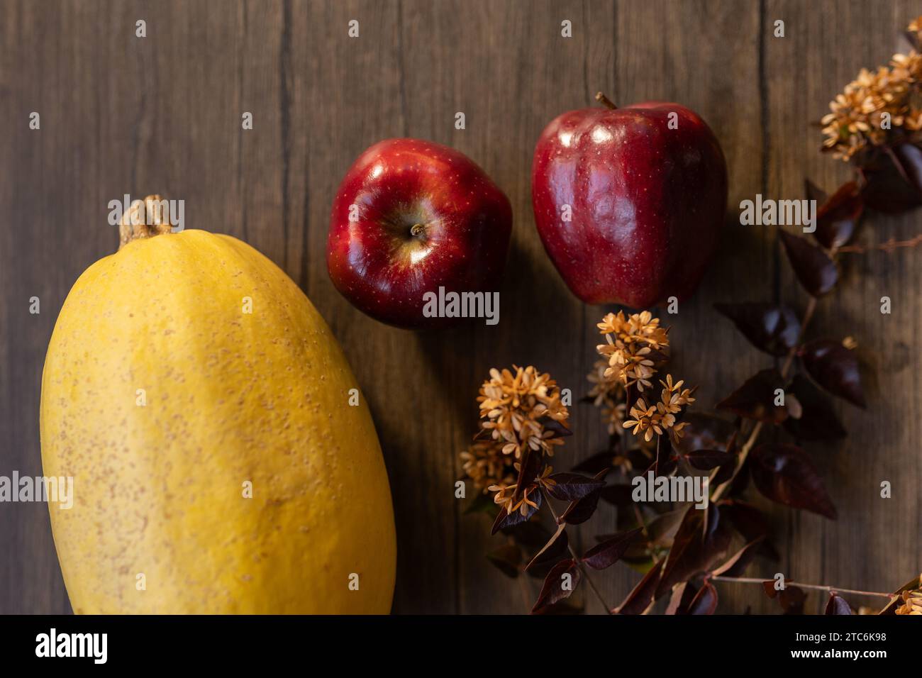 apples squash and fall foliage against wooden background Stock Photo ...