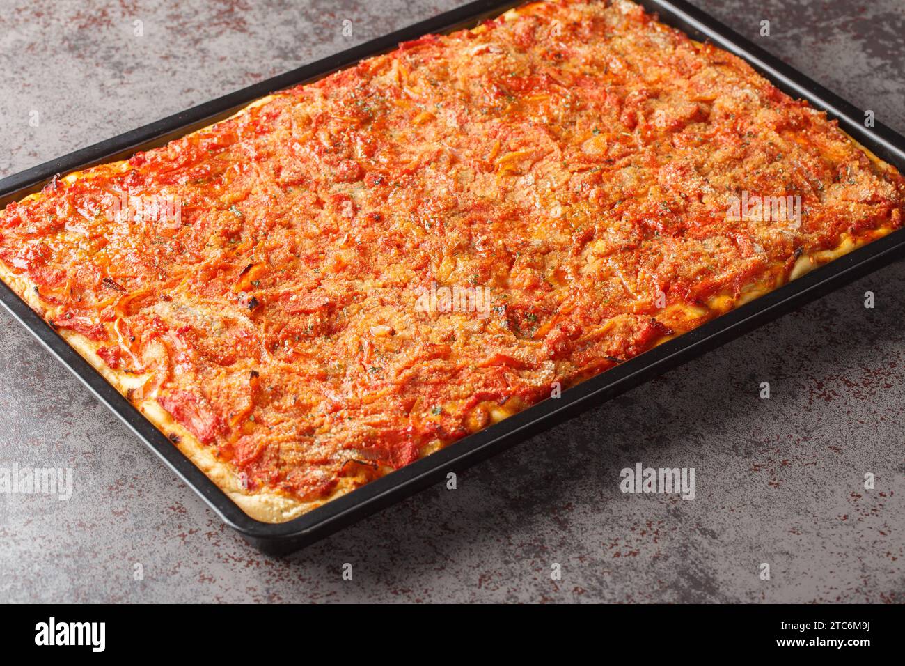 Sfincione most popular Sicilian pizza a thick flatbread seasoned with tomato sauce, anchovies ...