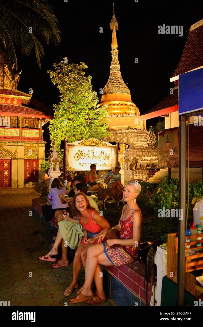 Two Foreign Women enjoying evening at Walking Street Night Market Old City Chiang Mai Thailand ...